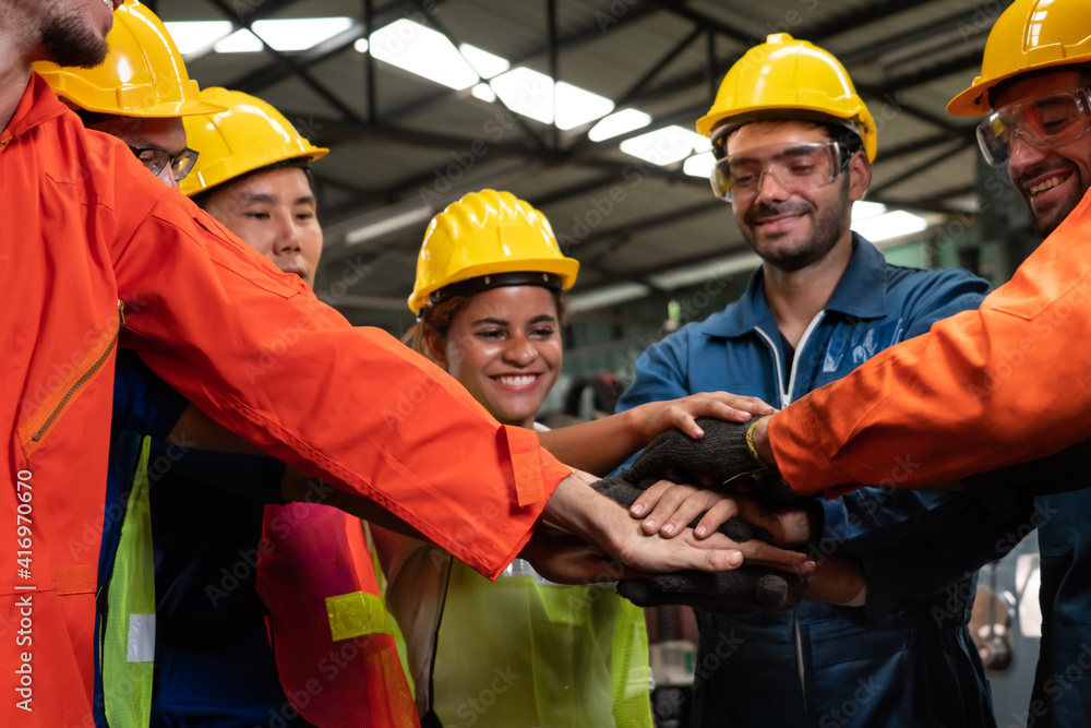 Skillful worker stand together showing teamwork in the factory ...