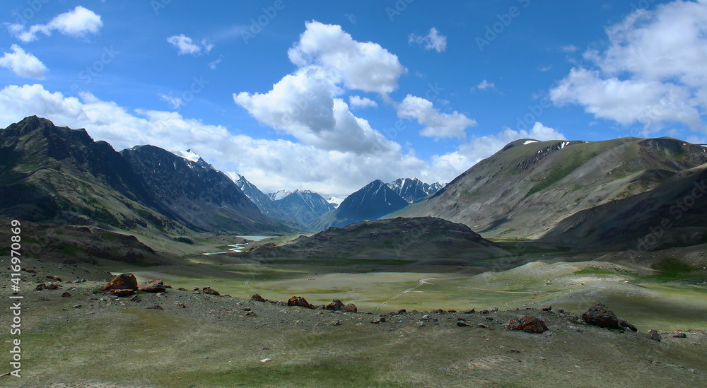 A wide alpine valley of the Akkol river in Altai with a small mountain ...