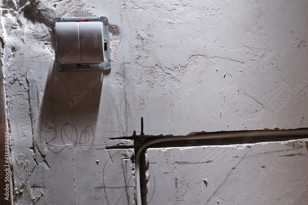 A sample of laying an electric cable into a concrete wall of an ...