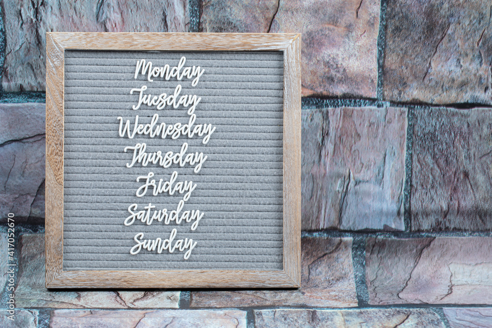 Happy weekdays poster written with letter symbols on the grey tissue ...