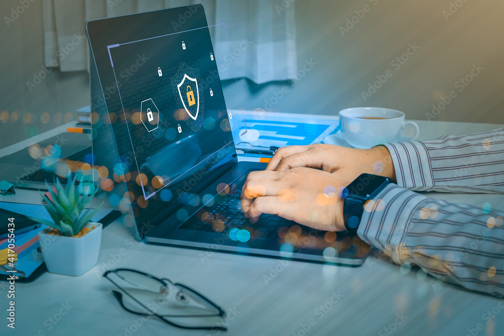 Foto de Person using a Laptop Computer with data protection, Cyber ...