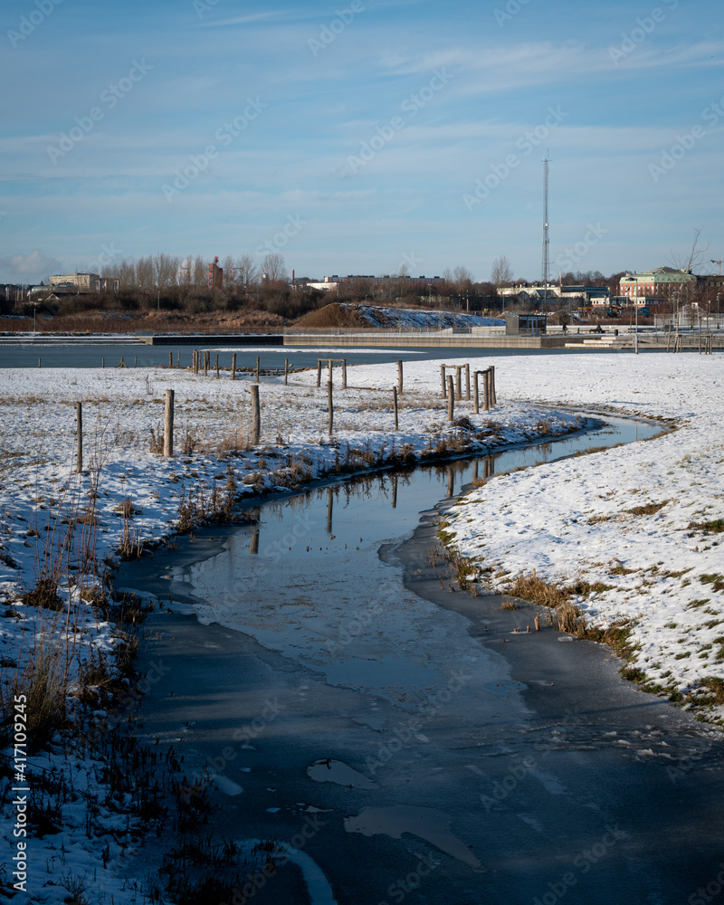 Ice cold stream of water in rural setting during winter in the outer ...