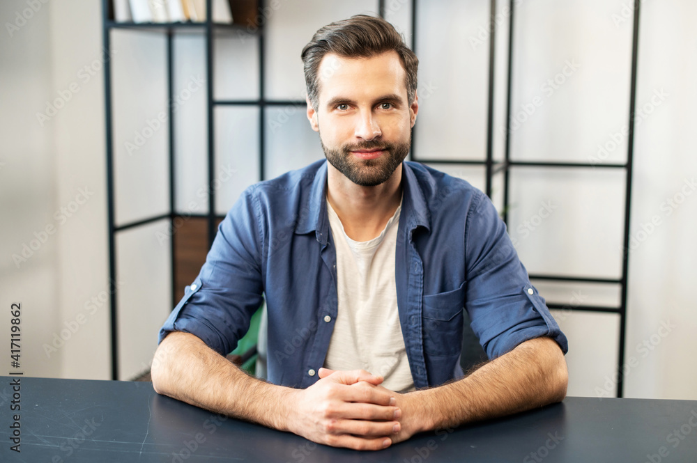 Young bearded guy hipster in casual clothes looking at camera, skilled ...