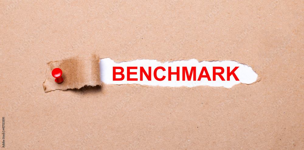 Beneath the torn strip of kraft paper attached with a red button is a ...