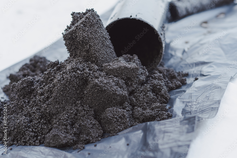 Pressed activated carbon for loading into a water filter Stock Photo ...