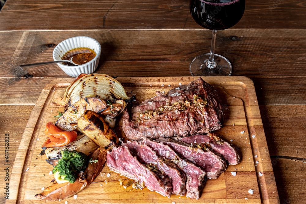 Argentine Cut Of Meat Called Vacio With Chorizos And Chimichurri Stock
