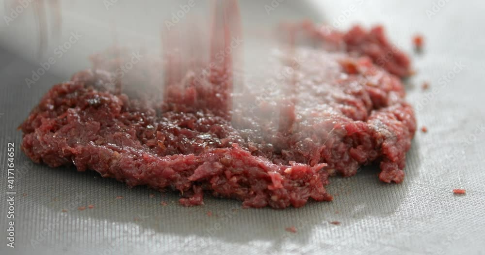 Horse meat finely chopped using sharp knife, preparing Steak Tartare ...