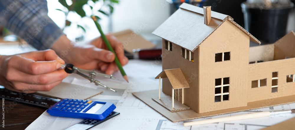 Workplace of architect - construction drawings, scale model and tools ...