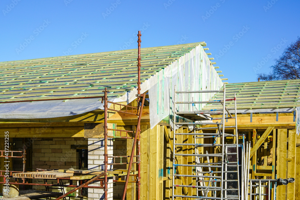 new wooden construction building in the construction process, roofing ...