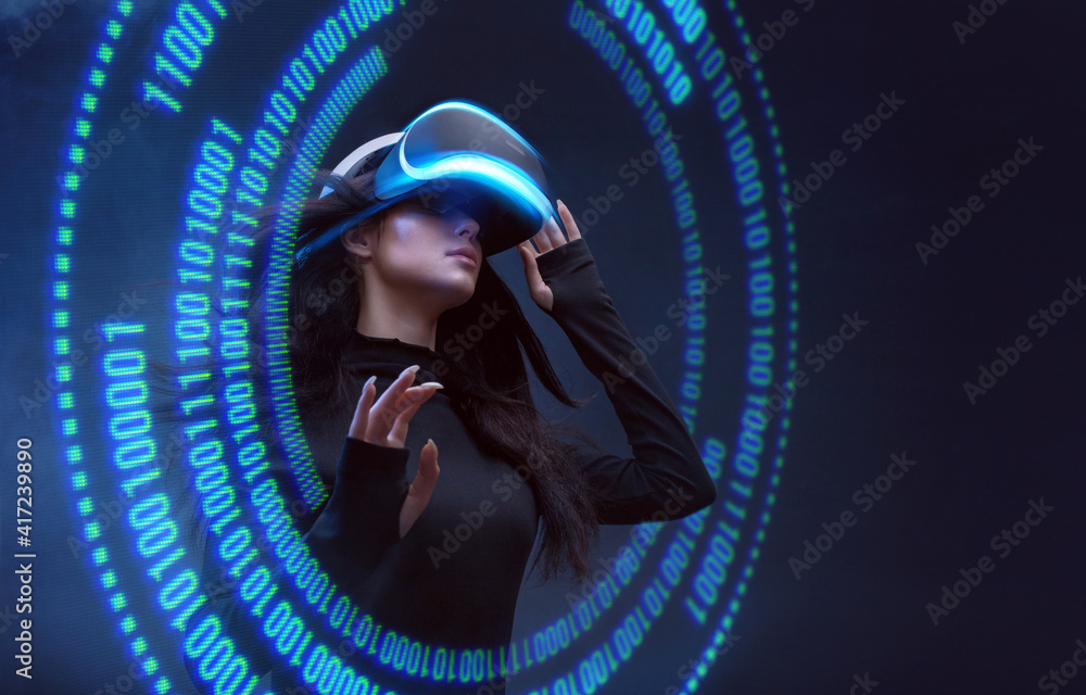 Woman on dark virtual reality background. Female using VR helmet. Augmented reality, future ...