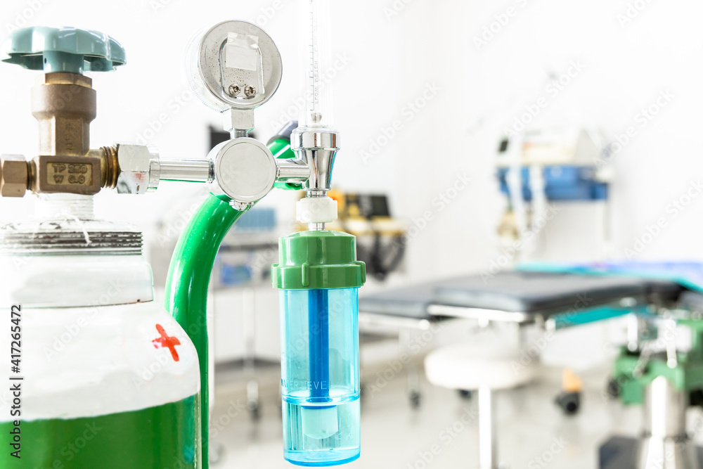 Medical oxygen flow meter shows low oxygen with patient bed in hospital ...