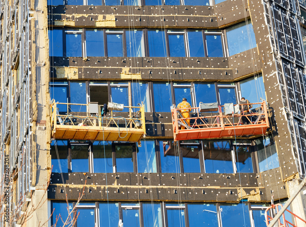 Facade repair and wall insulation with mineral insulation in a modern ...