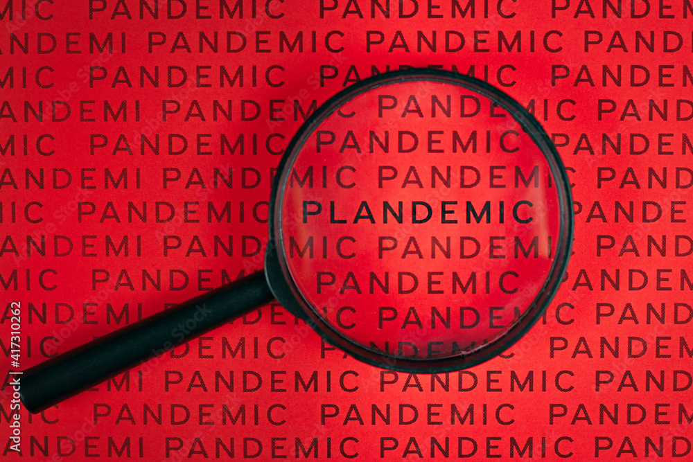 Magnifying glass over word 'Plandemic' between lines wird word 'Pandemic'. Concept for ...