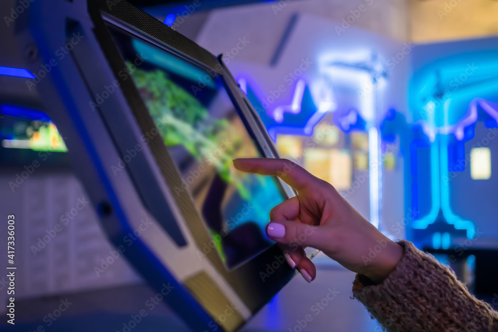Woman hand using touchscreen display of floor standing tablet kiosk ...
