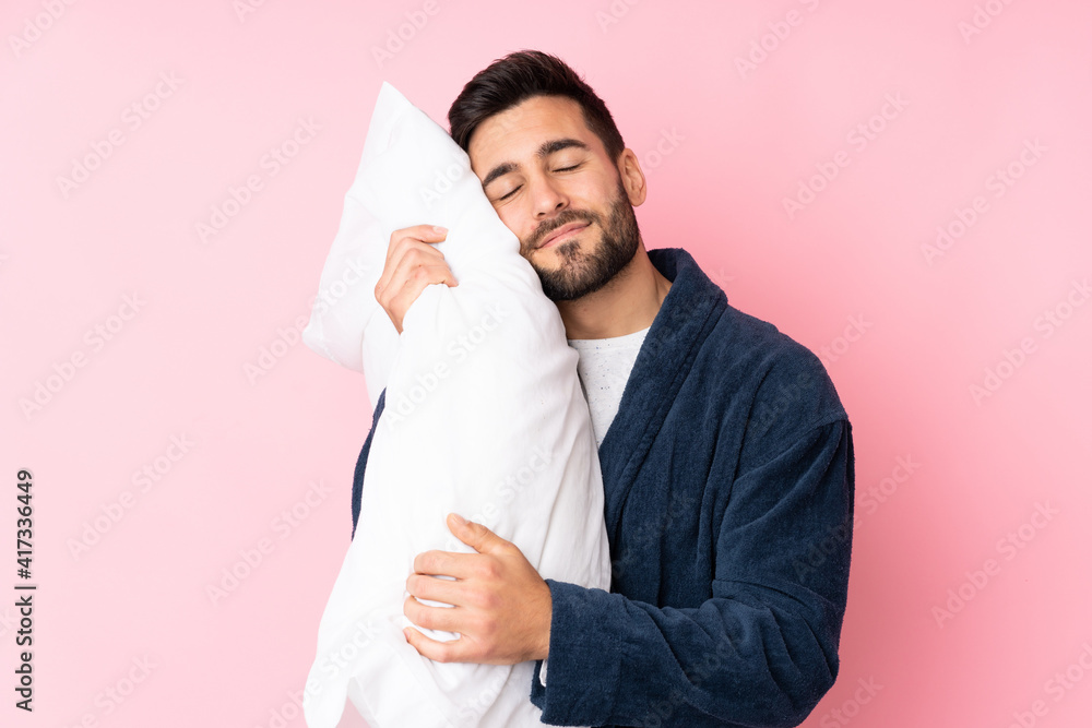 Young man going to sleep isolated on pink background Stock Photo ...