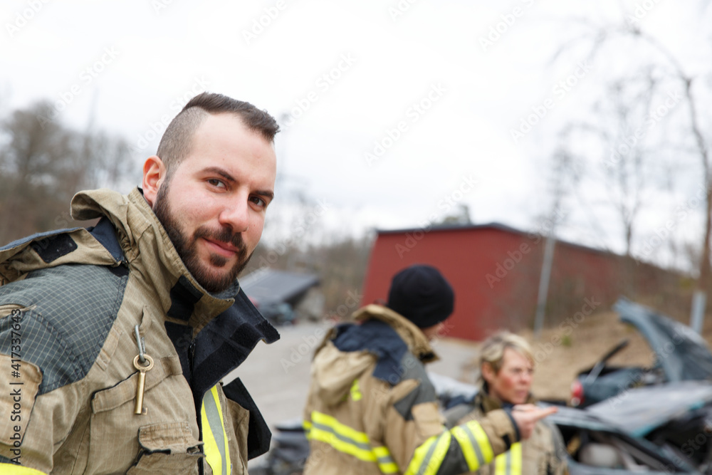 Smiling firefighter looking at camera Stock Photo | Adobe Stock