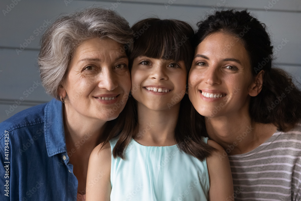 Close up portrait of happy three generations of Hispanic women, child ...