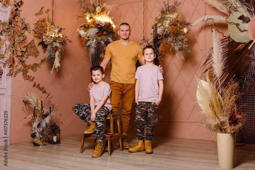 Strong father and two sons in identical shoes look at the camera Stock ...
