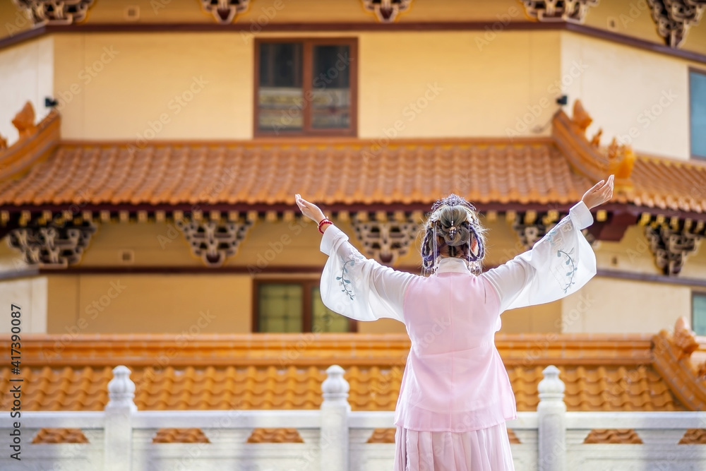 Back side of cheerful beautiful asian chinese girl wearing traditional ...