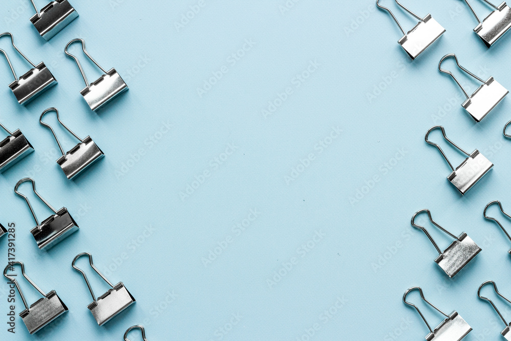 Frame of silver paper binder clips top view. Office supplies pattern ...