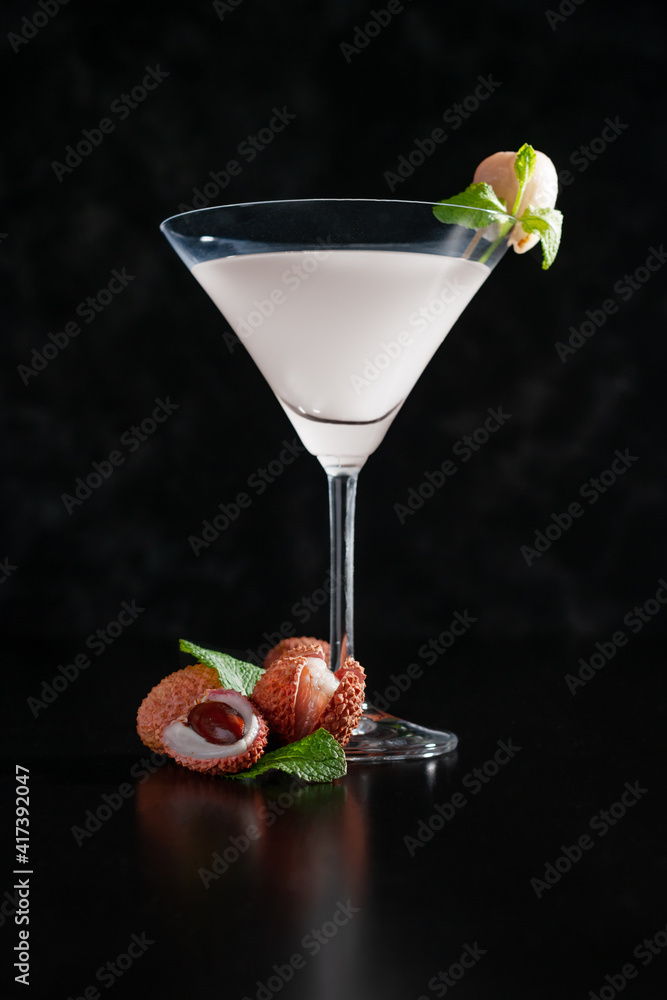 An elegant lychee drink decorated with lychee fruit. Drink in a martini ...