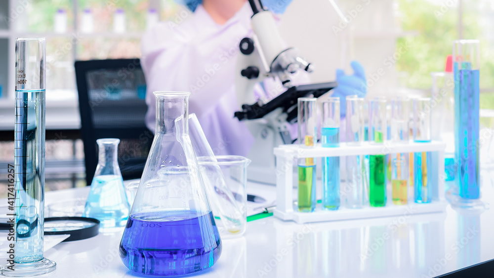 Blue solution in flask and measuring cylinder and the laboratory ...