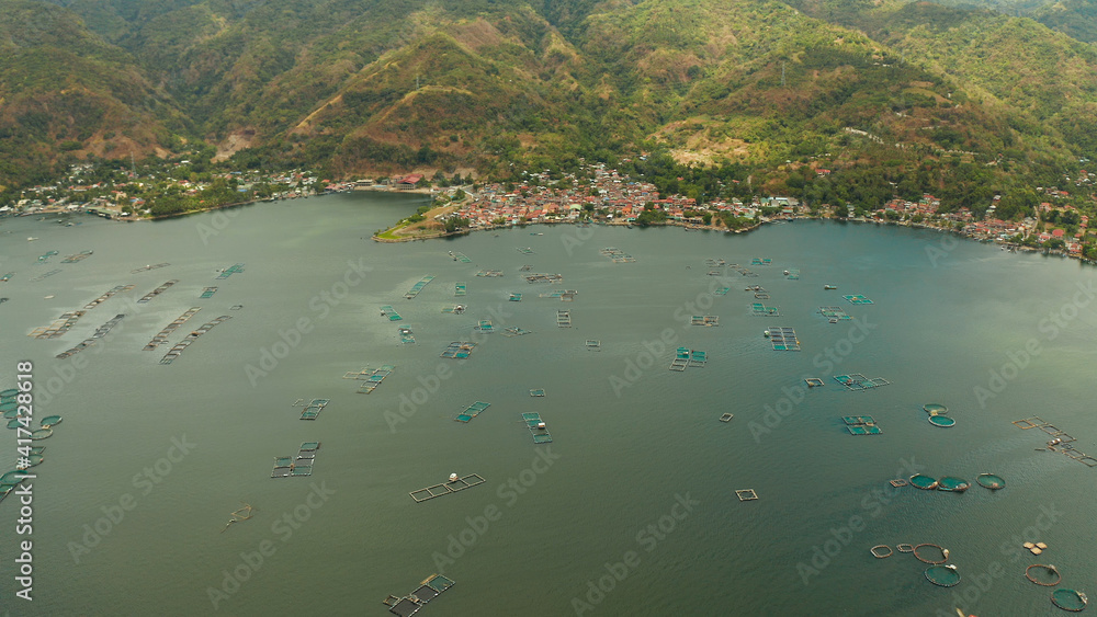 Aerial view of fish farm with cages for fish and shrimp on the lake ...