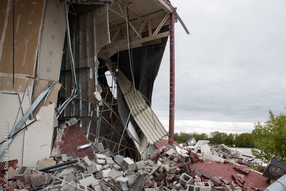 Old strip mall retail space being demolished; interior exposed and pile ...