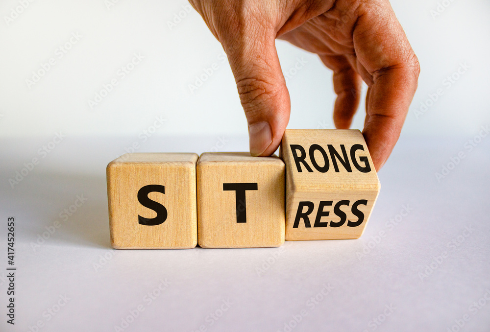 Strong stress symbol. Businessman turns wooden cubes with words 'strong ...