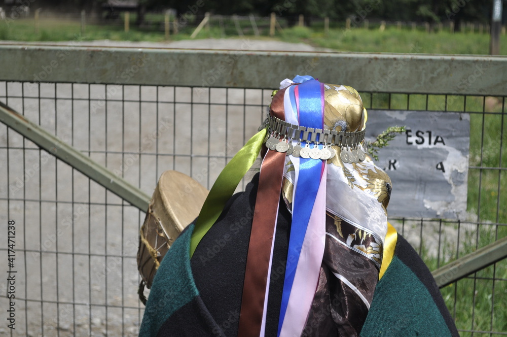 Detail of an unrecognizable Mapuche woman playing a traditional ...