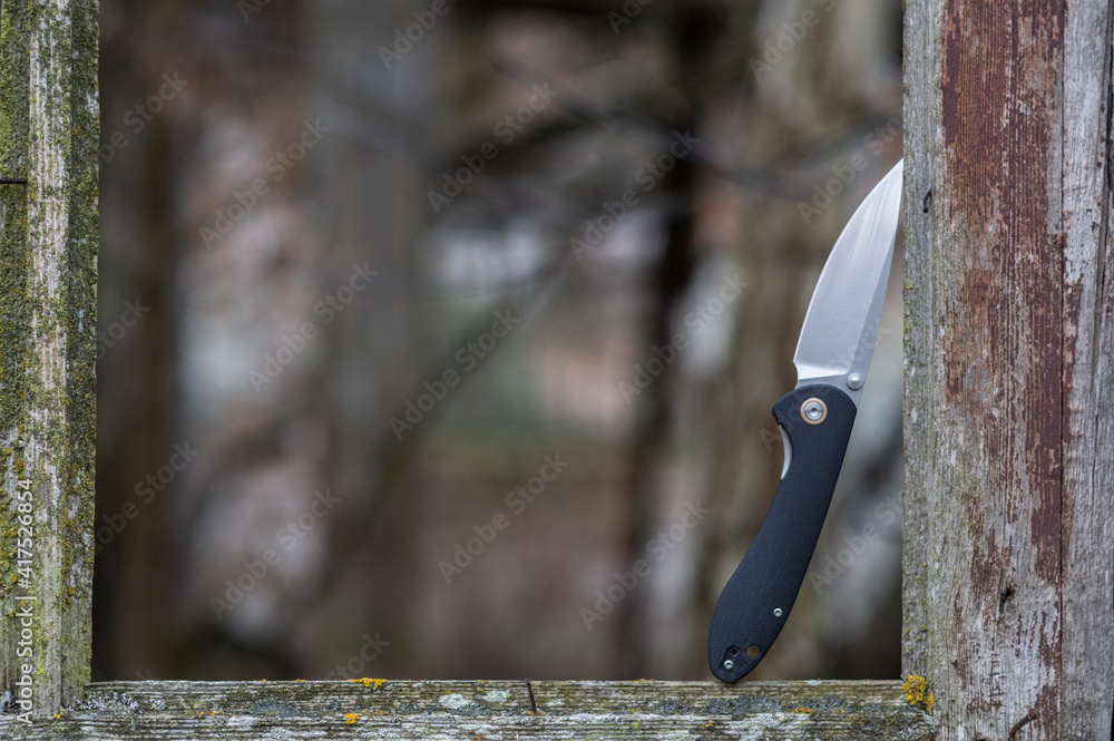 Photo of a knife on the street in a window opening. Knife on an old ...