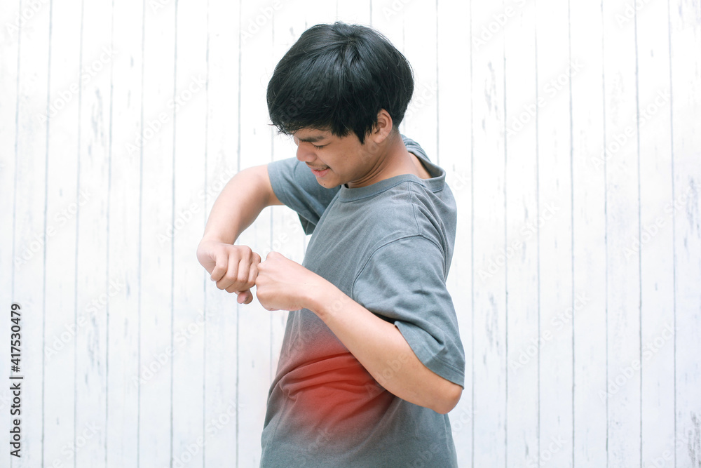 Fotografia do Stock: Asian young man felt pain in his waist, concept of ...