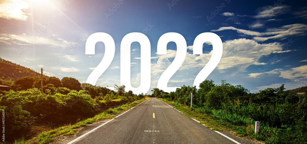 The word vision 2022 behind the tree of empty asphalt road at golden ...