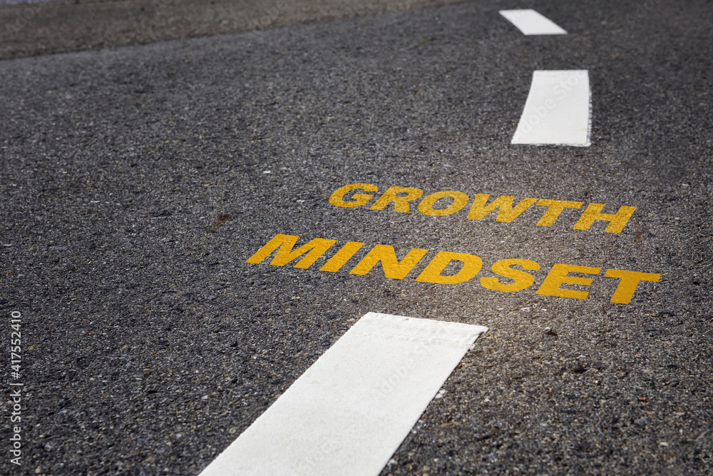 Growth mindset written on asphalt road surface. Self development to ...