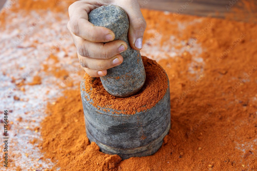 Indian woman hand powdering Indian spices Red chilly , chili paprika ...
