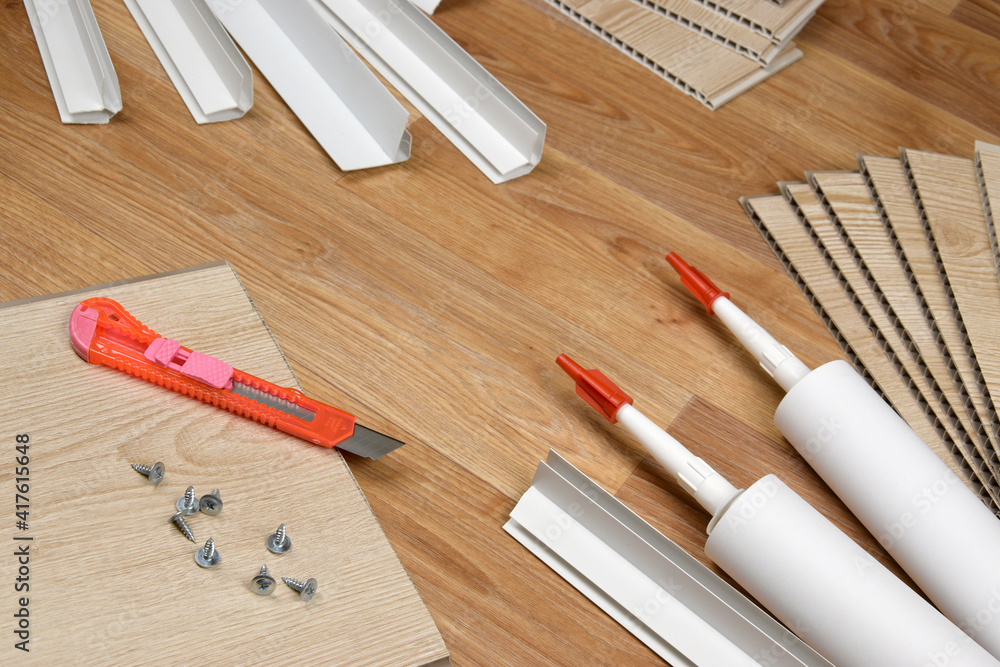 Set of items for PVC ceiling indoor works. Assembly adhesive bottles ...