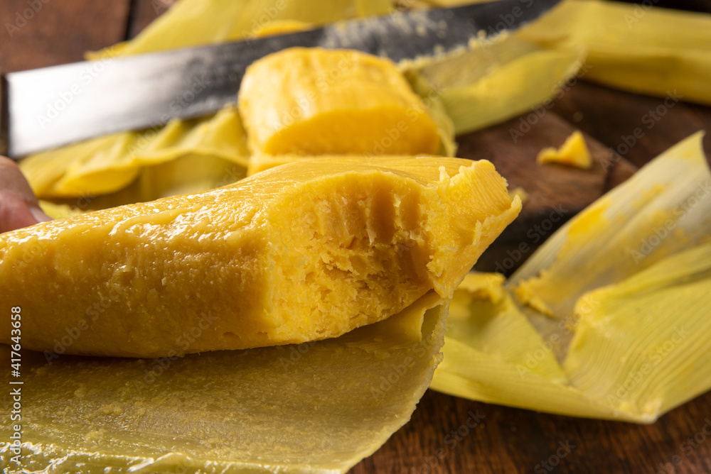 Pamonha, Brazilian corn food, called pamonha. On a rustic table with ...