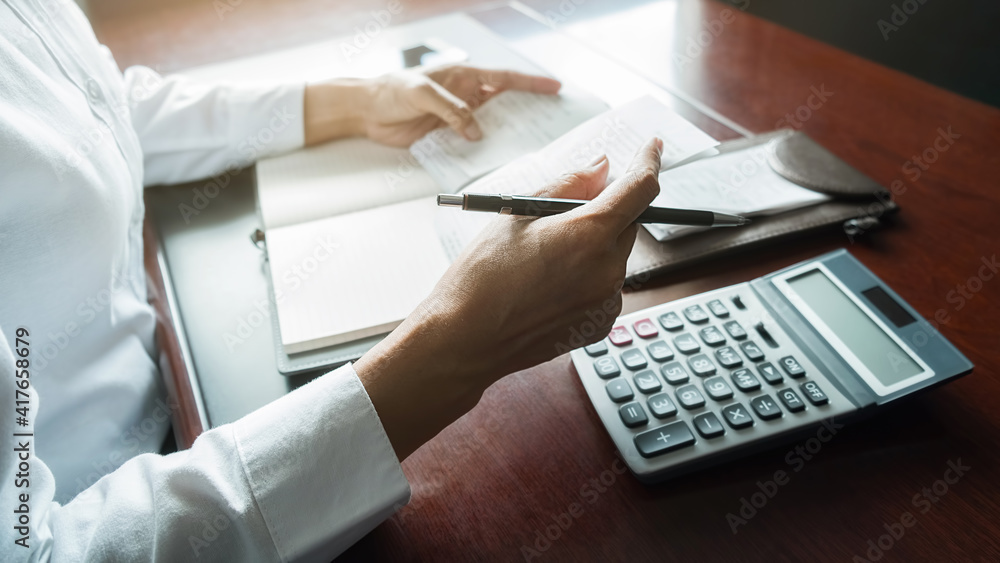 Woman with bills and calculator. Woman using calculator to calculate ...