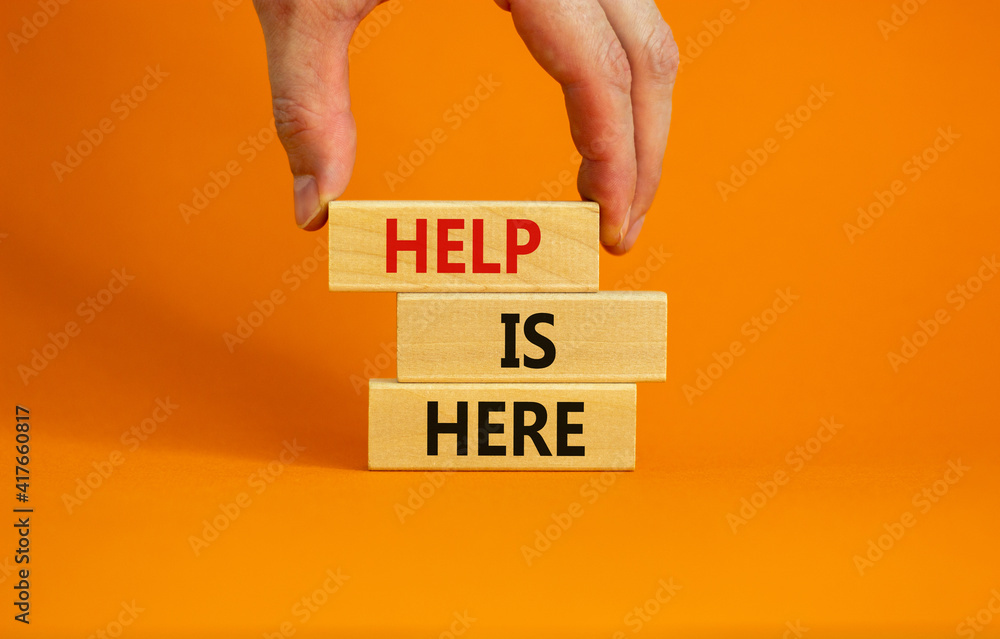 Help is here symbol. Wooden blocks with words 'Help is here' on ...