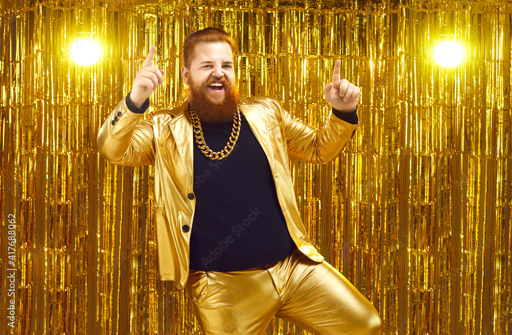 Rich chubby man in a golden suit dances at a party or disco on a bright ...