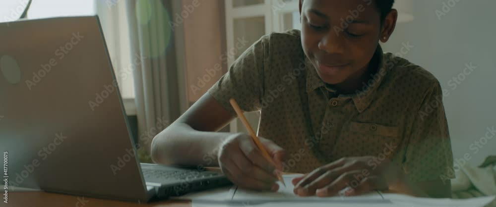 African American Black kid boy studying from home, having a video with ...