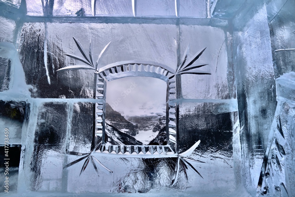 Window in Ice palace wall. View of mountains through the window. Lake ...