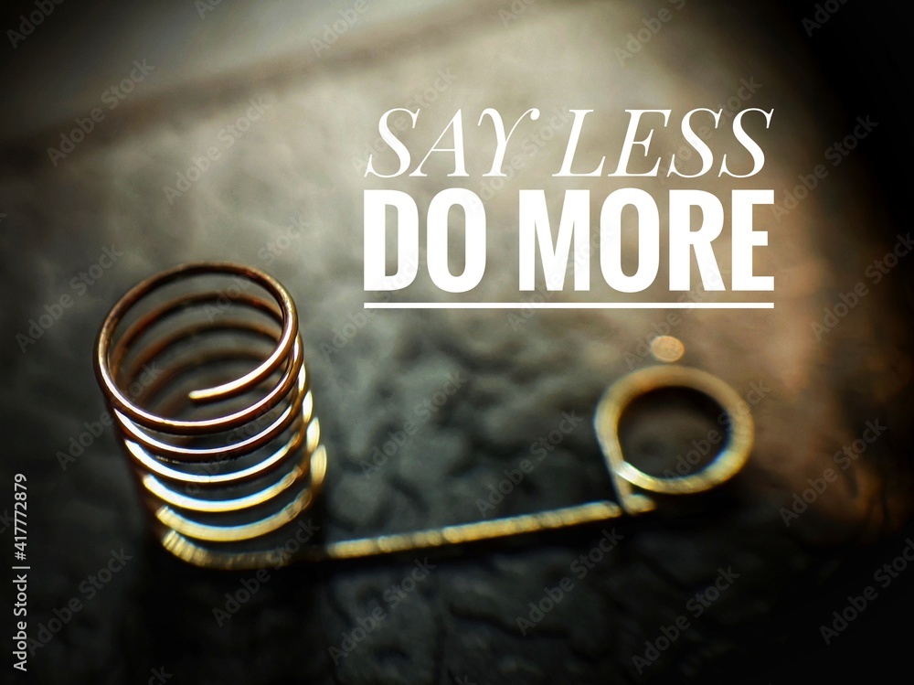 'Say Less, Do More' motivation quote with a spring in blurry background ...