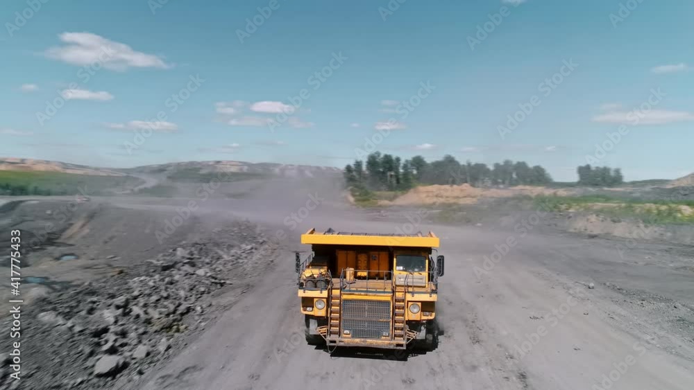 Large quarry dump truck. Loading rock in dumper. Loading coal into ...