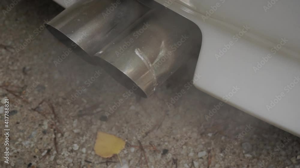 The dual exhaust pipe of a powerful car emitting smoke. Footage ...