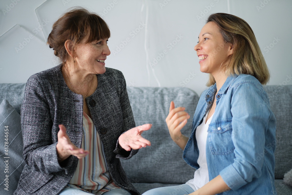 adult daughter talking to his elderly mom. mother and daughter having ...