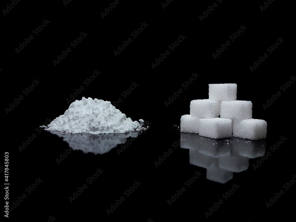 Cocaine drug powder pile and ump sugar cubes on black background, sugar ...