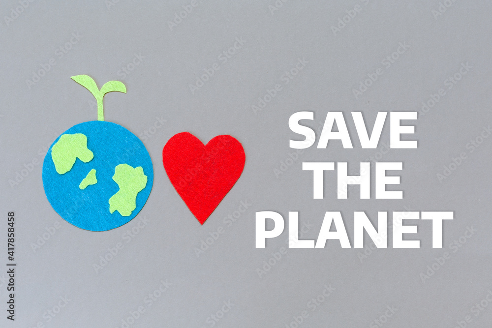 Save the planet. A felt-cut symbol of the planet earth with plant and a ...
