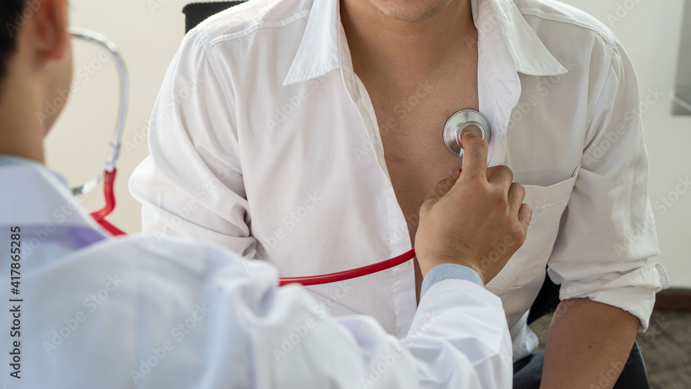 Doctors listen to the patient's heartbeat with a stethoscope, hospital sounds, physical ...