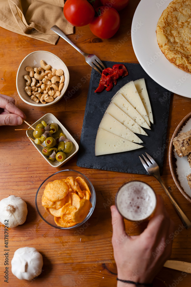 Vertical top view Spanish tapas bar table with various typical dishes ...